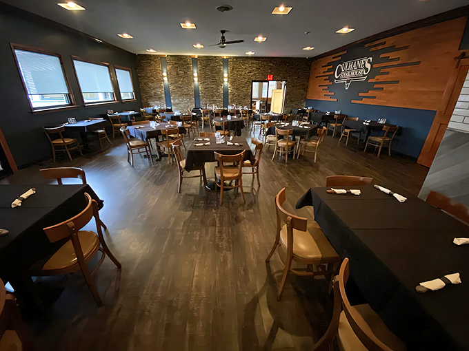 Inside, the warm wood tones and blue accent wall create that perfect "fancy enough for date night, casual enough for Tuesday" steakhouse vibe.