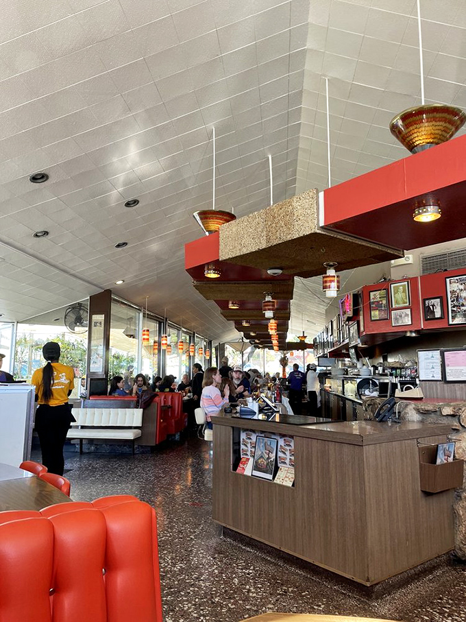 Red vinyl booths, terrazzo floors, and pendant lamps create the perfect backdrop for comfort food conversations that flow as freely as the coffee.