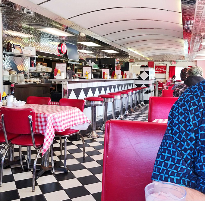 Classic red vinyl meets checkerboard floors in this quintessential diner interior. It's not Instagram-designed nostalgia—it's the real deal that Instagram tries to copy.