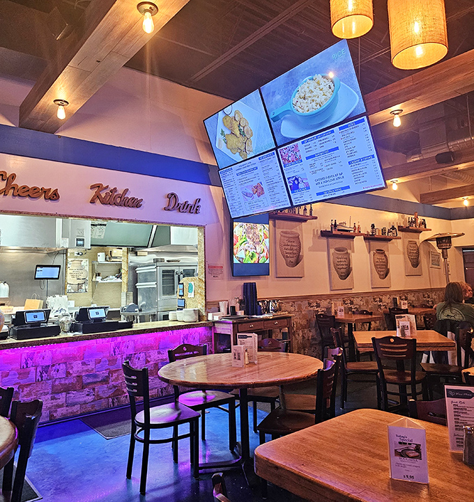 Where modern meets Mediterranean&mdash;purple-lit counters, warm wood tables, and digital menus create an atmosphere that says "stay awhile and order seconds."