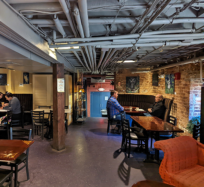 Industrial chic meets cozy comfort where exposed pipes and brick walls create the perfect backdrop for conversation and contemplation.