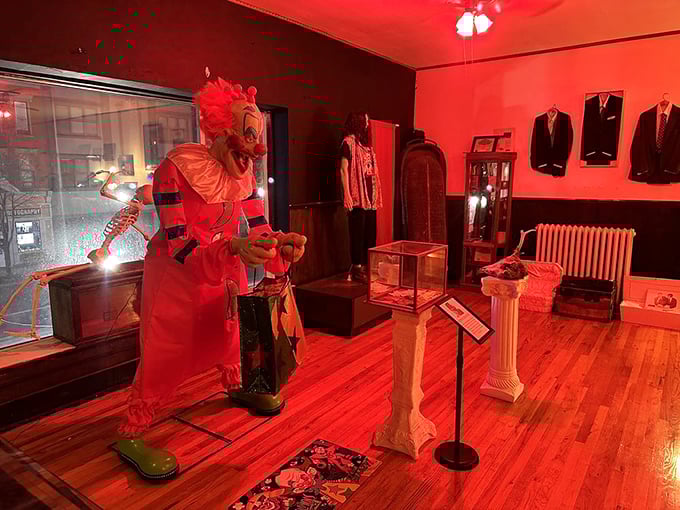 Bathed in blood-red lighting, this creepy clown figure isn't here to make balloon animals&mdash;unless they're anatomically correct heart balloons.