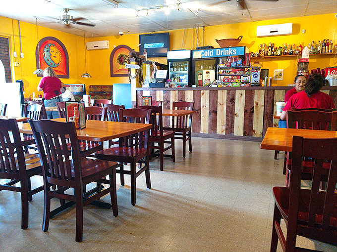 Sunshine-yellow walls and rustic wooden furnishings create that rare dining atmosphere where you instantly feel like a regular, even on your first visit.