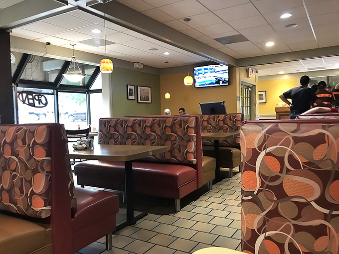 Inside, retro-patterned booths create cozy islands of comfort where strangers become friends over steaming cups of coffee.