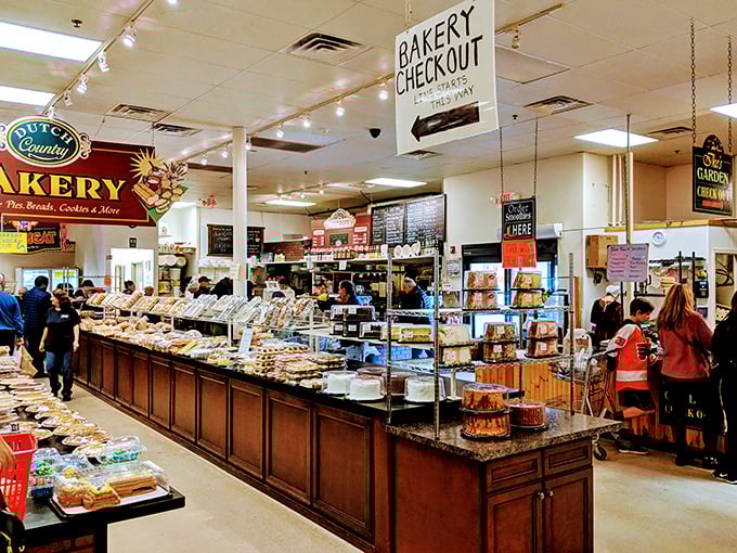 Bakery heaven awaits inside, where display cases burst with handcrafted treats. The morning rush resembles a polite version of the Oklahoma land grab.