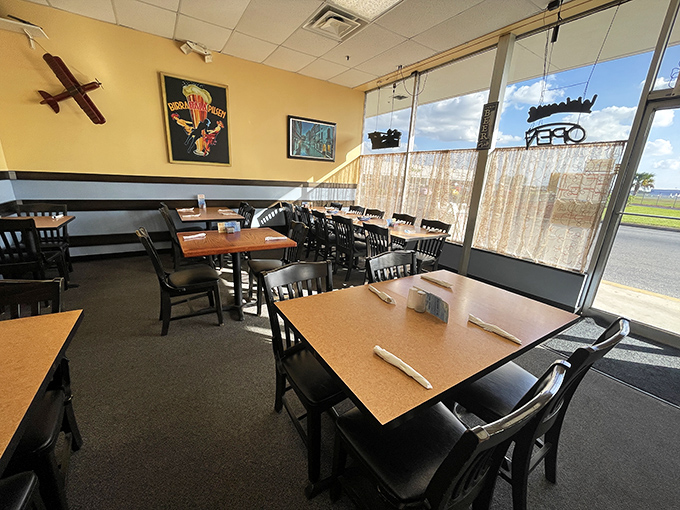 Simple tables, yellow walls, and art that says, "We care more about what's on your plate than what's on our walls." Comfort over pretension wins every time.