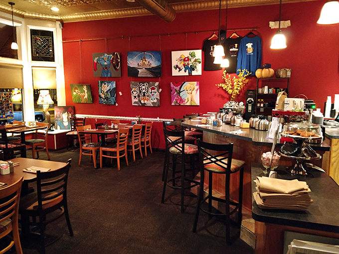 Vibrant red walls adorned with local artwork create a warm, energetic backdrop for breakfast bliss. The tin ceiling adds vintage charm to this beloved neighborhood spot.