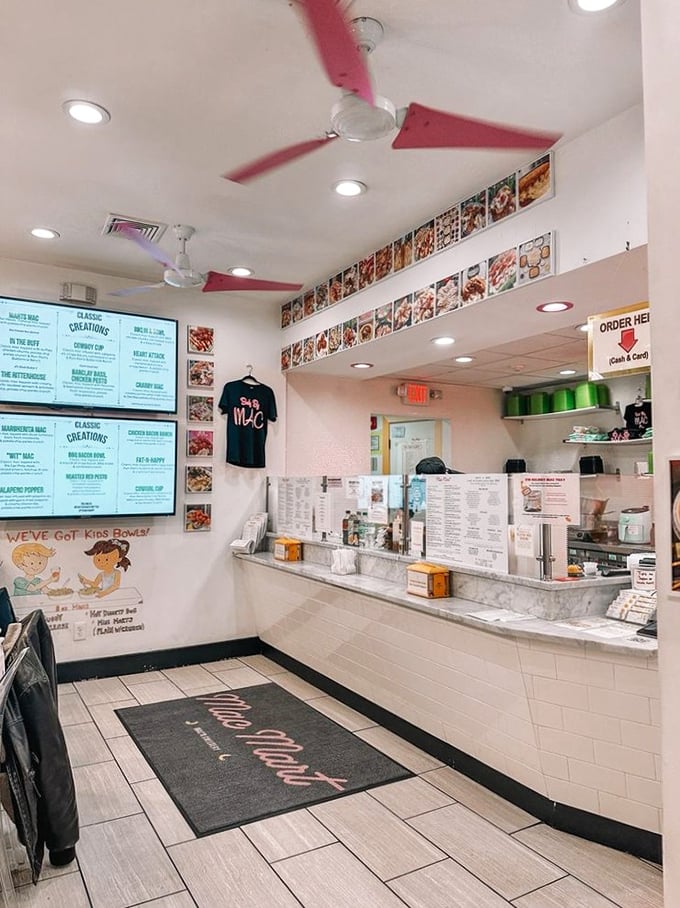 Inside, pink ceiling fans whirl above a pristine counter where mac and cheese dreams come true daily.