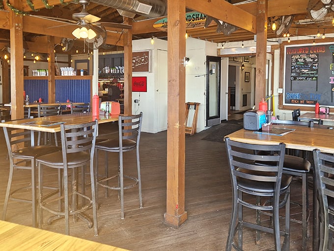 Wooden beams, simple tables, and string lights create that "I've discovered something special" atmosphere that makes vacation meals memorable. Coastal casual at its finest.