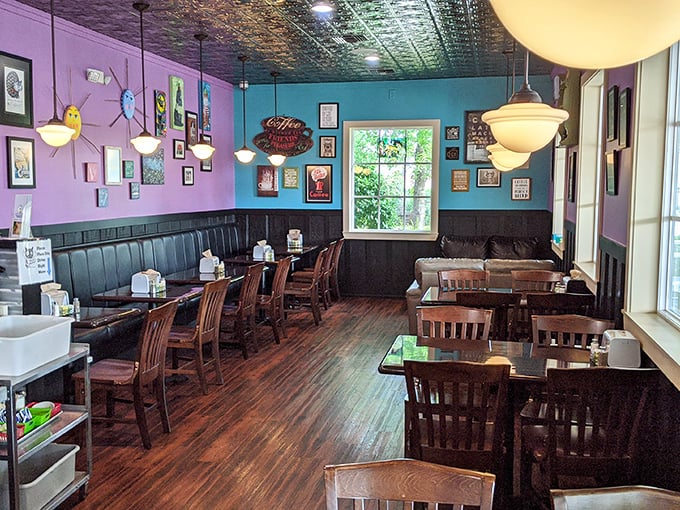 Vibrant turquoise and purple walls create a whimsical backdrop for serious eating. The pressed tin ceiling adds vintage charm that whispers, "Stay awhile."