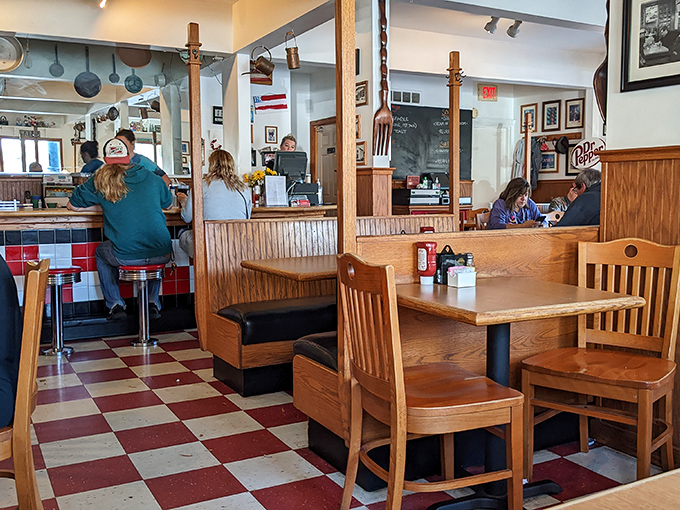 Classic red and white checkered floors set the perfect stage for wooden booths where locals swap stories and visitors become regulars over plates of morning perfection.