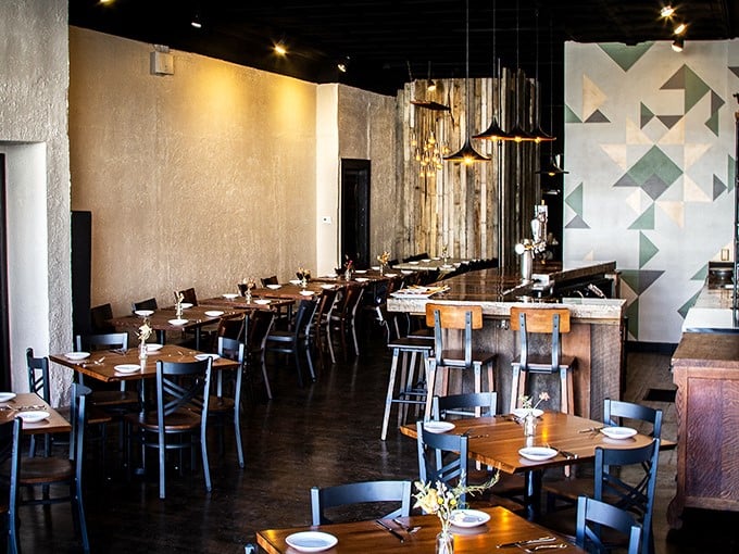 Modern farmhouse chic meets comfortable dining. The geometric wall art adds just enough hipness to remind you this isn't your grandma's country kitchen.