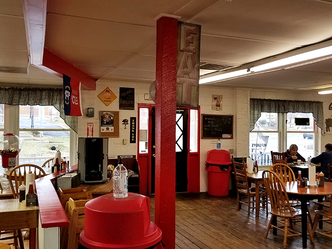 Red support beams and wooden chairs create that perfect "come as you are" atmosphere where comfort trumps pretension and barbecue reigns supreme.