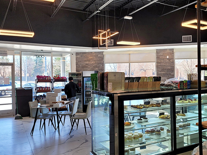 Modern meets cozy in this thoughtfully designed space where geometric lighting fixtures hover like delicious UFOs over marble floors.