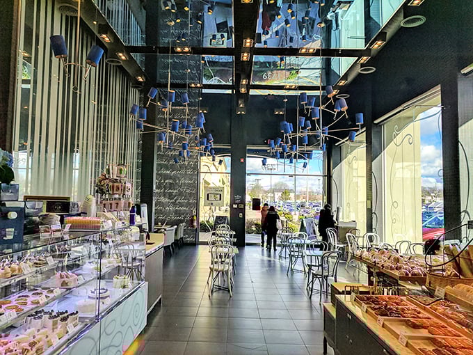 Step inside to discover a sleek interior where whimsical blue ceiling fixtures dance above gleaming display cases filled with temptations that make willpower utterly useless.