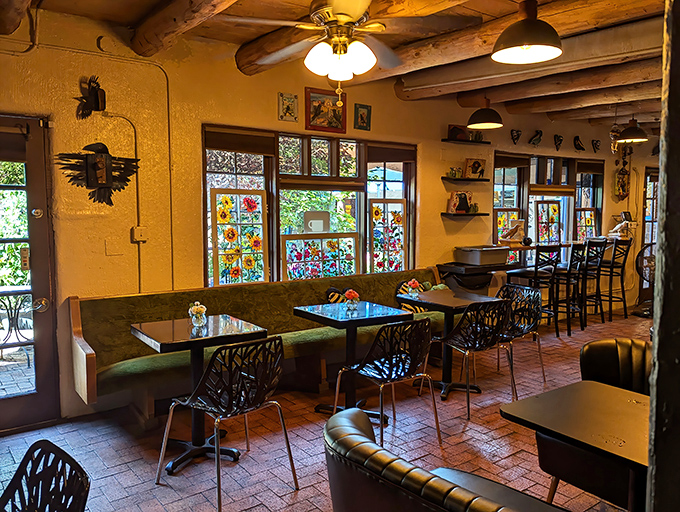 Sunshine captured indoors. Blackbird's golden walls and wooden vigas create the perfect backdrop for coffee contemplation, while stained glass windows paint the room with light.