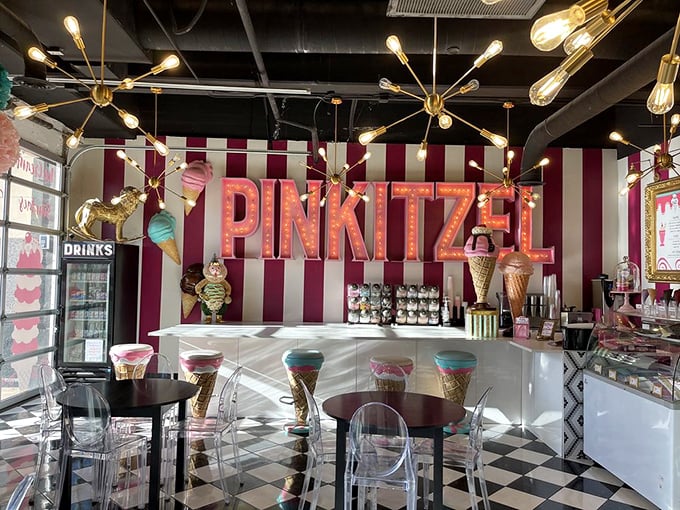 Step inside and the real magic begins—pink stripes, sputnik chandeliers, and a checkered floor straight out of a dessert dreamscape.