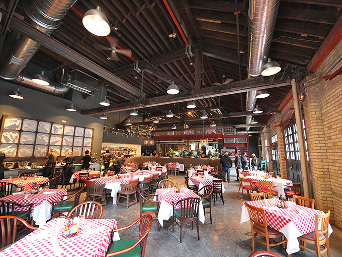 Inside, industrial chic meets coastal comfort with those iconic red-and-white checkered tablecloths that practically whisper, "Good seafood happens here."