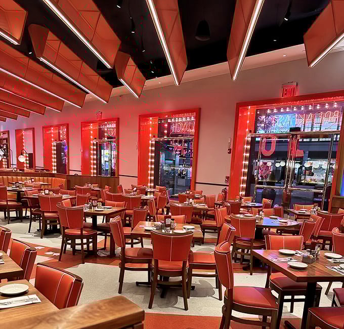 Inside Junior's, those signature red booths aren't just seats&mdash;they're front-row tickets to New York's greatest culinary theater.