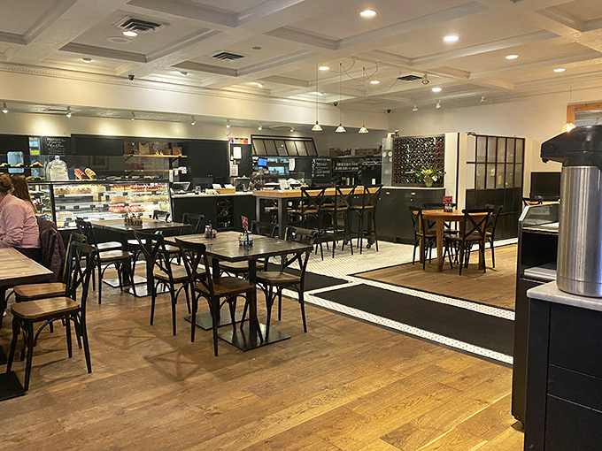 Inside, warm wooden floors meet crisp white ceilings in a space that feels like the living room of that sophisticated friend who always serves the best desserts.