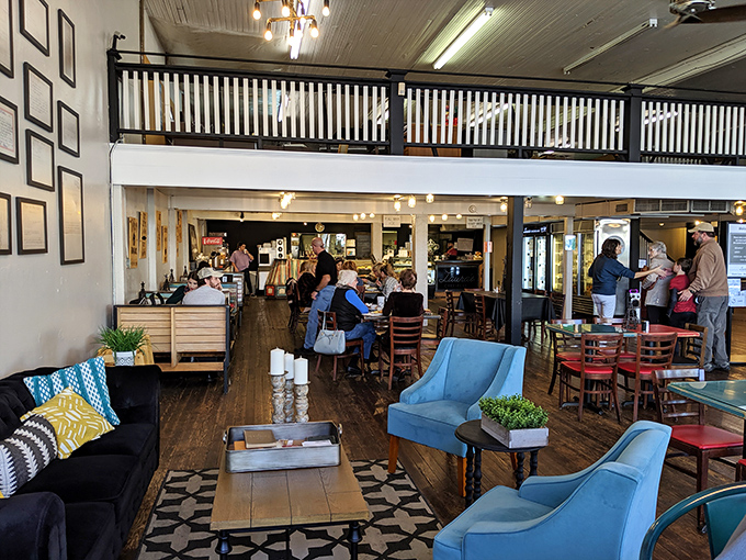 Step inside to discover a two-story haven where modern comfort meets small-town charm. Those blue armchairs aren't just furniture&mdash;they're invitations to linger.