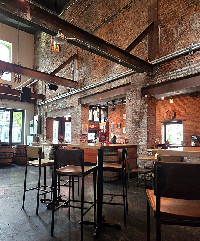 Soaring ceilings, exposed brick, and barrel tables create the perfect backdrop for bourbon-fueled conversations. Industrial meets comfort in this whiskey lover's paradise.
