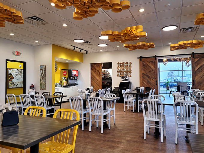 Golden wheels suspended from the ceiling create a cheese-inspired art installation, while the bright yellow accents remind you exactly what you came for.