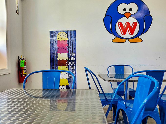 Blue metal chairs and that adorable penguin mascot create the perfect backdrop for the important decision-making that happens here: vanilla or chocolate?
