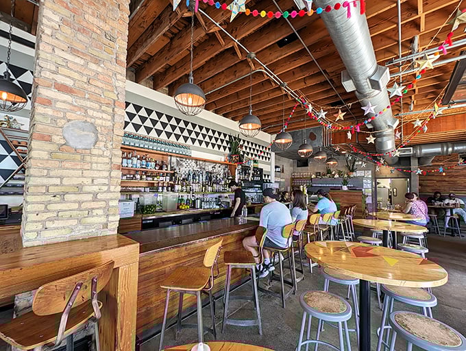 Industrial meets cozy in this thoughtfully designed interior, where exposed brick and wooden beams create the backdrop for tequila-fueled conversations.