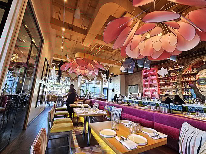 The interior's showstopping pink flower light fixtures hover like delicious UFOs above diners. It's like someone designed a restaurant after asking, "What if Frida Kahlo opened a tequila bar?"