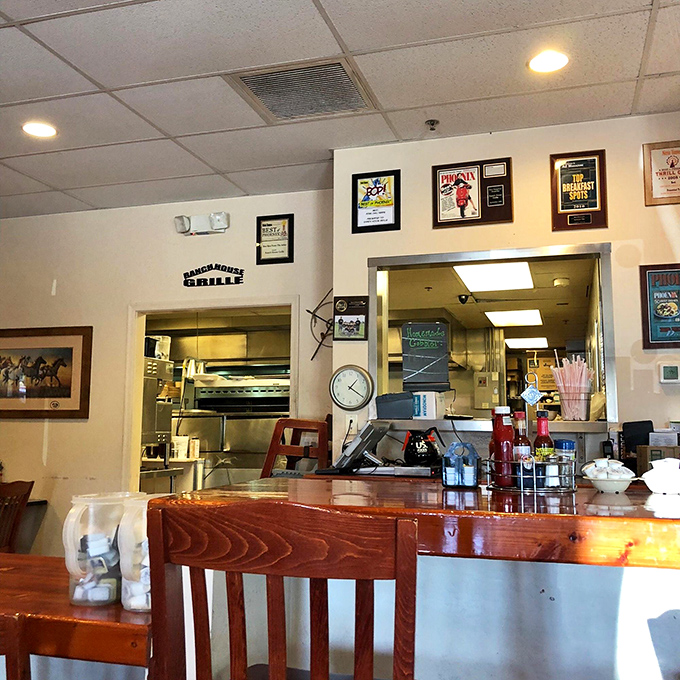 A glimpse into the kitchen's command center, where breakfast dreams materialize amid awards that tell the story of pancake perfection.