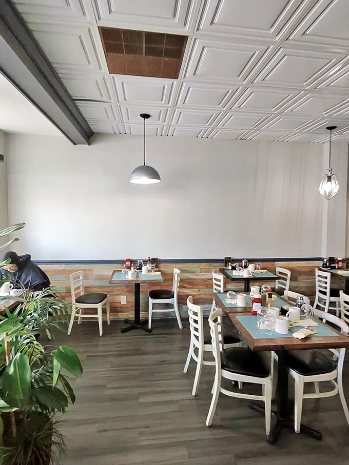 Clean lines, warm wood, and those signature white ladder-back chairs create the perfect canvas for pancake contemplation and coffee conversations.