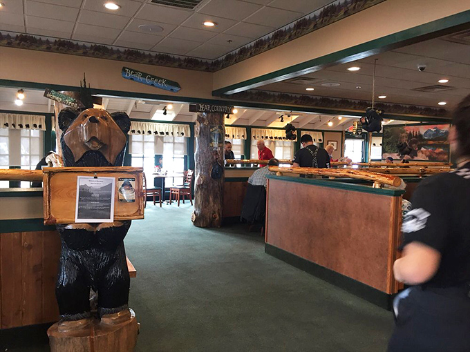 Step inside and you're greeted by a wooden bear sentinel, standing guard over a dining room where cabin chic meets breakfast paradise.