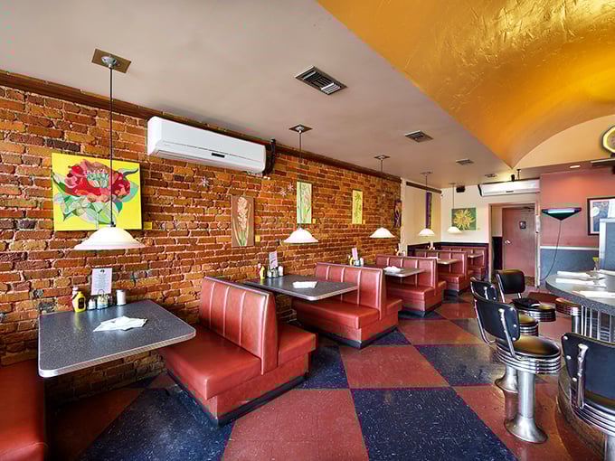 Classic red vinyl booths against exposed brick walls create that perfect diner atmosphere&mdash;where conversations flow as freely as the coffee.