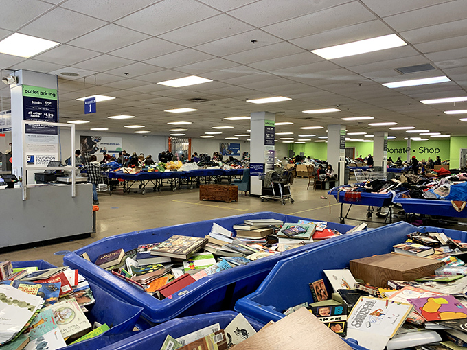 Welcome to the land of the blue bins! This vast warehouse space transforms shopping into a thrilling expedition where every table holds potential discoveries. 
