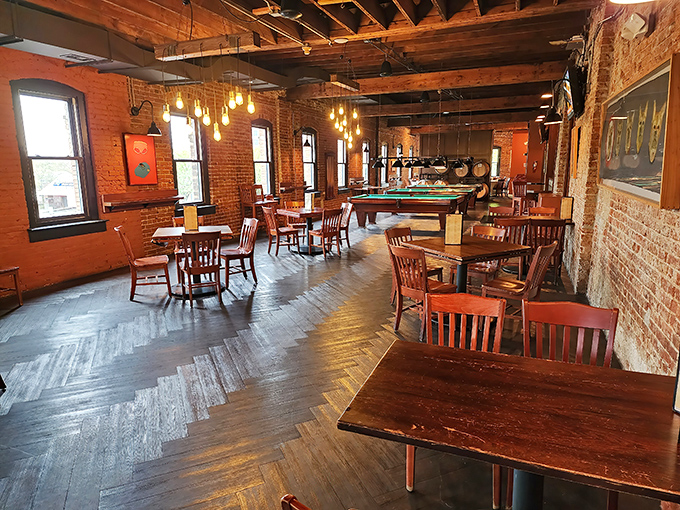 Exposed brick walls, wooden beams, and herringbone floors create the perfect backdrop for both serious conversations and lighthearted celebrations.