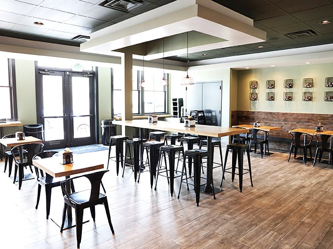 Modern minimalism meets comfort in this bright, airy space. The black metal chairs and wooden tables say, "We're serious about food, not fancy furniture."