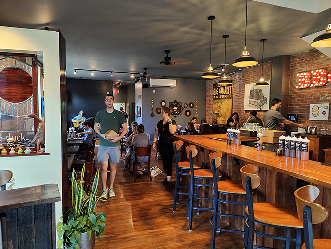 Inside, exposed brick meets warm wood tones while vintage-inspired lighting creates the perfect atmosphere for serious comfort food indulgence.
