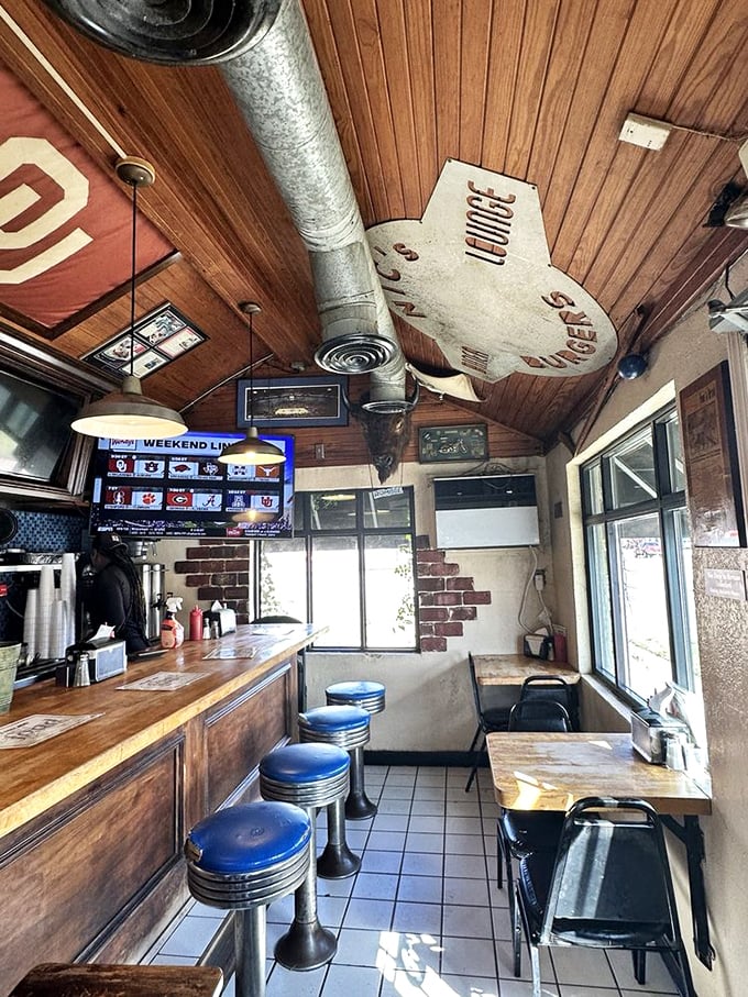 Inside Nic's, every inch tells a story. Wood-paneled walls, blue counter stools, and exposed ductwork create the perfect no-frills dining atmosphere.