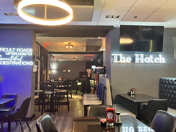 Step inside and the modern-meets-cozy vibe immediately wraps around you like a warm blanket, with that glowing neon sign promising delicious adventures ahead.