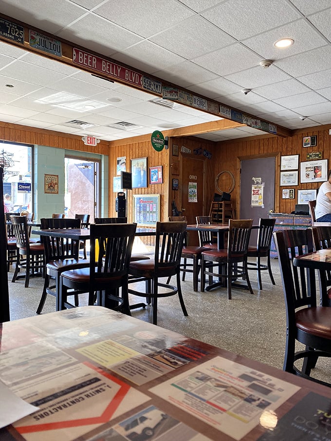 License plates line the ceiling like a roadmap of satisfied customers who've made the pilgrimage. Wood paneling never looked so appetizing.