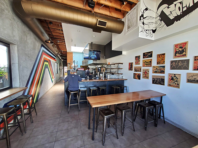 Comic book art meets industrial chic in Humble Potato's interior, where exposed ceiling ducts and wooden tables create the perfect backdrop for culinary adventures.