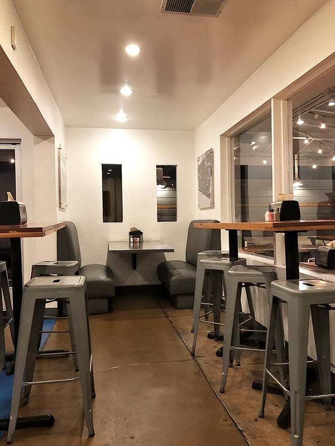 Minimalist interior with industrial touches creates the perfect distraction-free zone for what really matters: focusing entirely on that perfect burger-to-mouth trajectory.