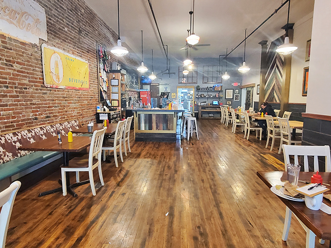 Classic diner geometry: orange-swirled carpet, warm wood tones, and strategically placed tables for optimal people-watching or private conversation.