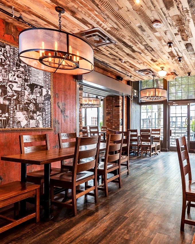 Step inside to find rustic wooden beams, exposed brick, and Edison bulbs creating the perfect atmosphere for what might be Ohio's most important chicken decision.