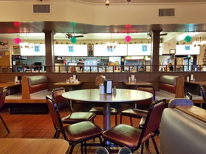 Classic diner booths where countless elbows have leaned and stories have been shared, all under the watchful glow of colorful hanging lights.