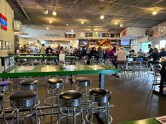 Inside, industrial-chic meets Texas comfort. Green tables, metal stools, and the promise of "WE GRIND SO FINE!" hovering over hungry patrons.