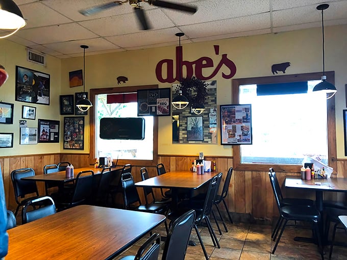 Inside Abe's, wood-paneled walls adorned with decades of memorabilia tell stories while the iconic red sign watches over hungry patrons.
