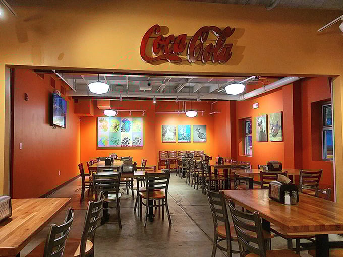 Orange walls and wooden tables create the perfect no-frills backdrop for the serious business of chicken consumption. Coca-Cola sign included for proper Southern authenticity.