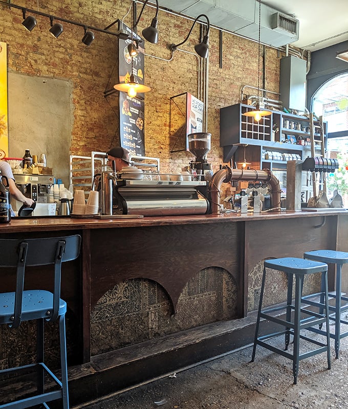 Industrial chic meets sandwich artistry at this counter. The exposed brick walls have probably witnessed more food epiphanies than a cooking show marathon.